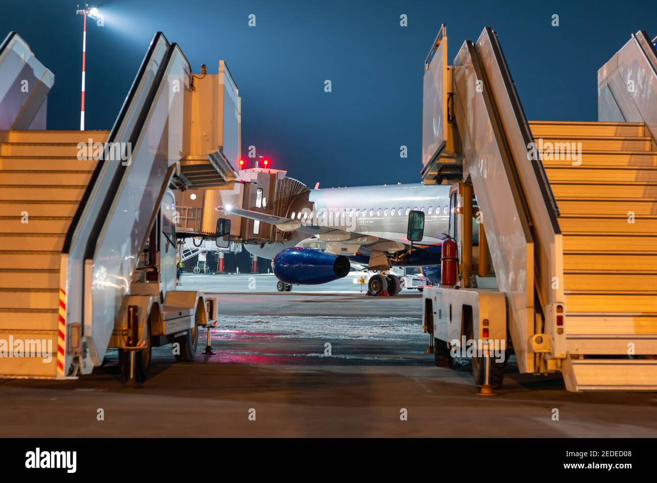 A view behind the mobile passenger ramps at the jet plane standing at ...