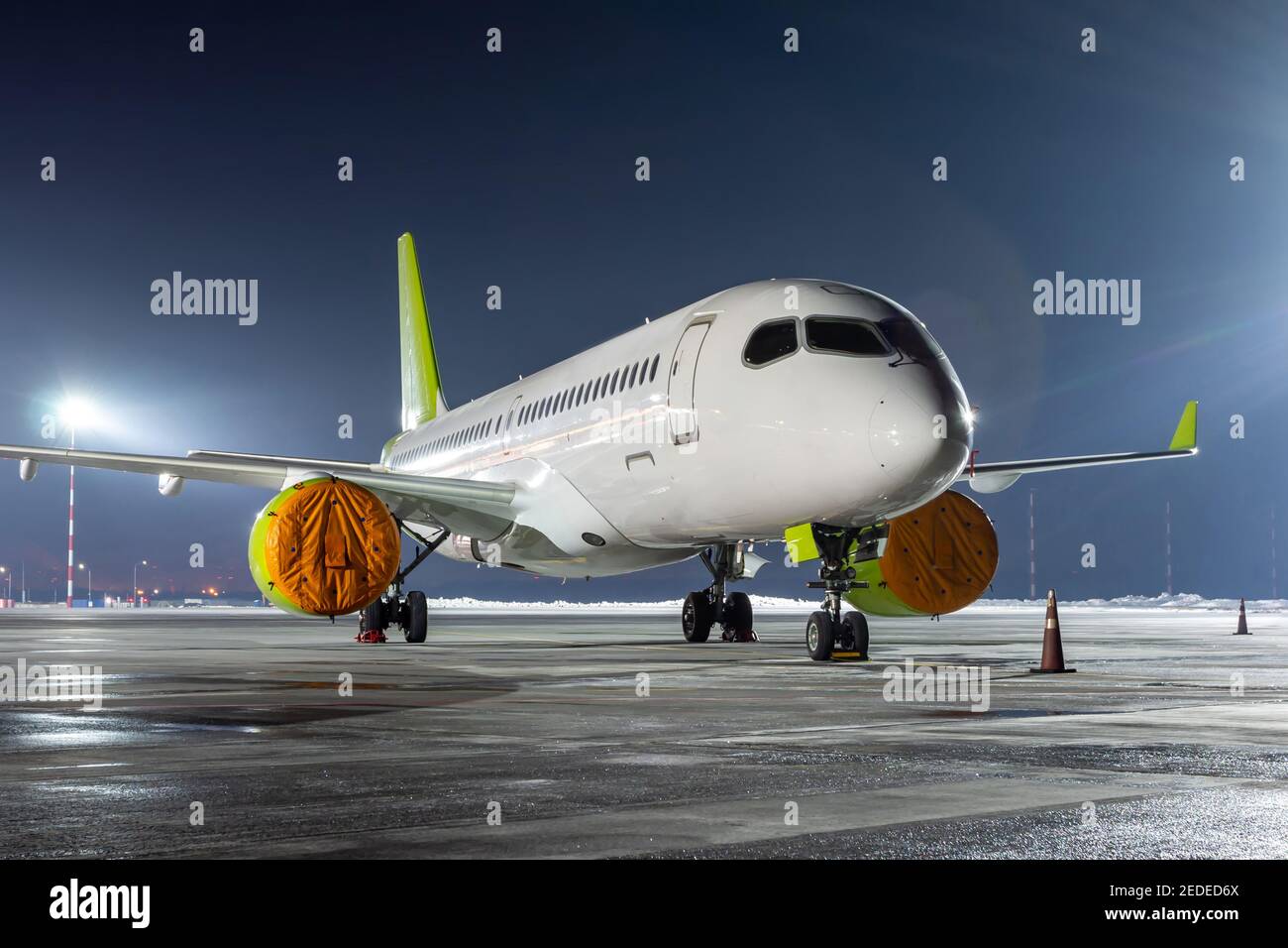 Modern passenger aircraft on the night airport apron Stock Photo - Alamy