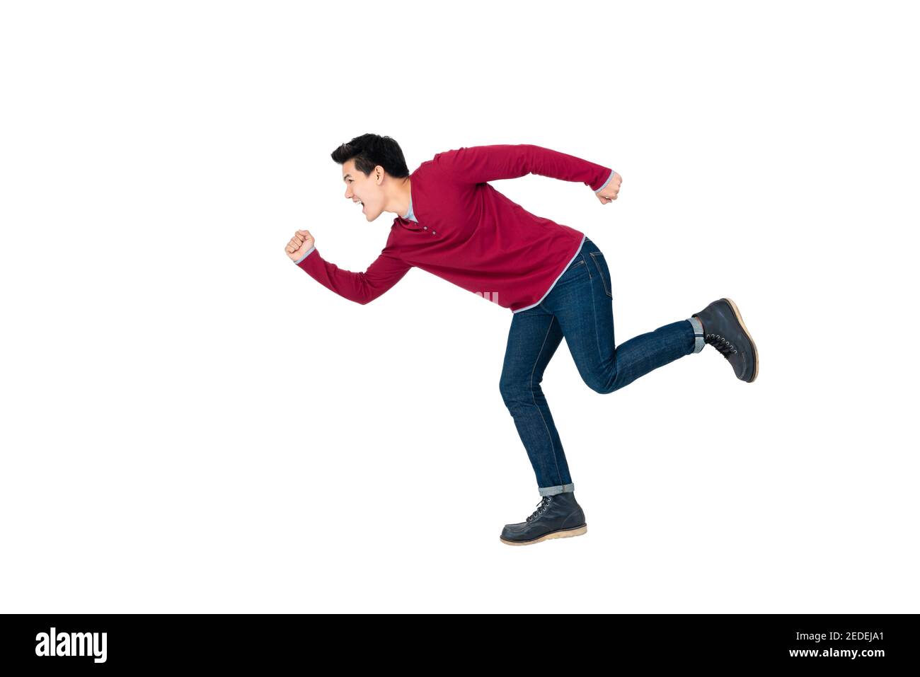 Young energetic Asian man in casual clothes running studio shot ...