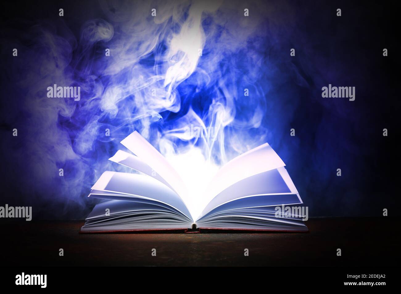 Open magic book on dark background Stock Photo - Alamy