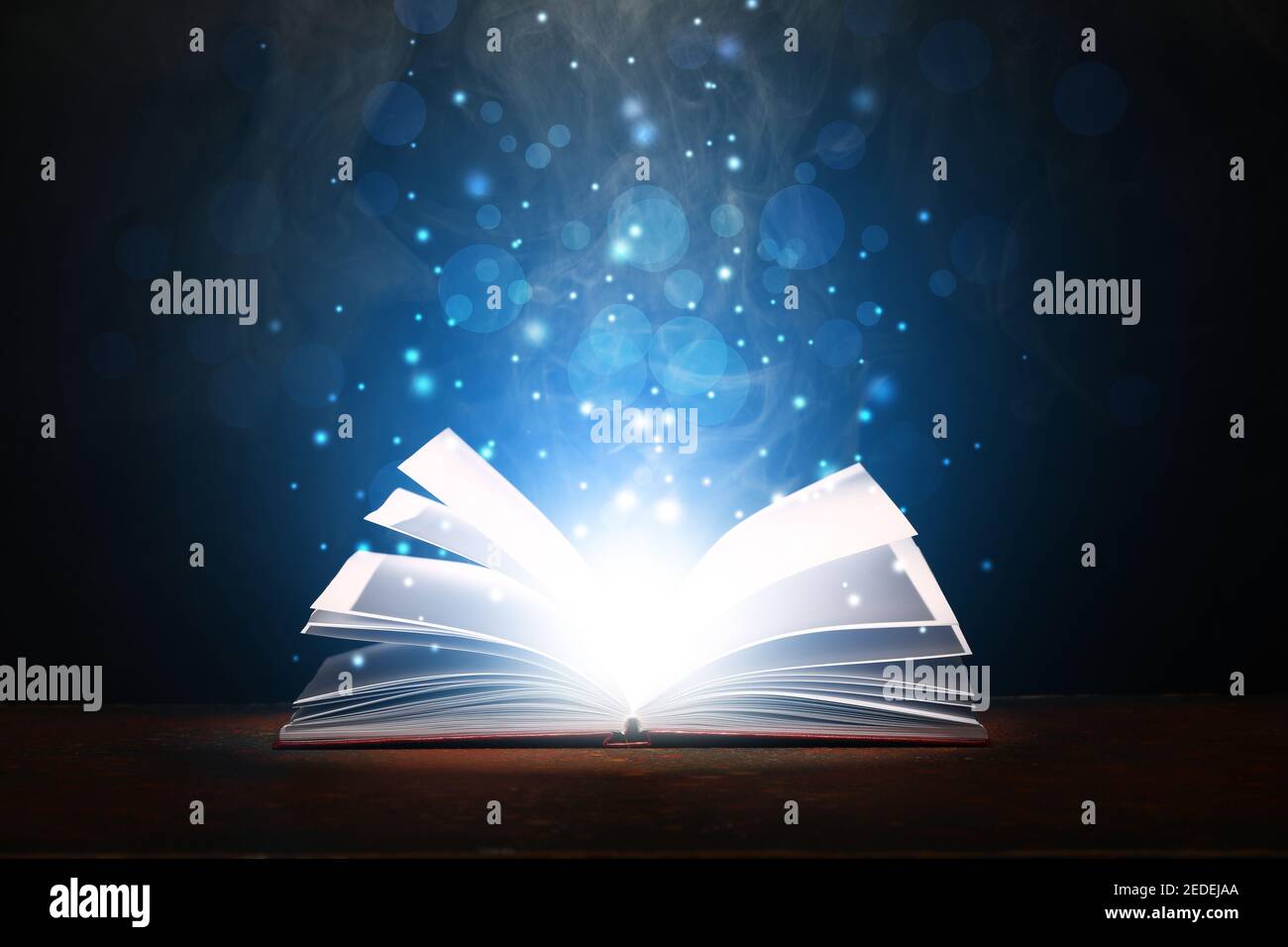Open magic book on dark background Stock Photo - Alamy