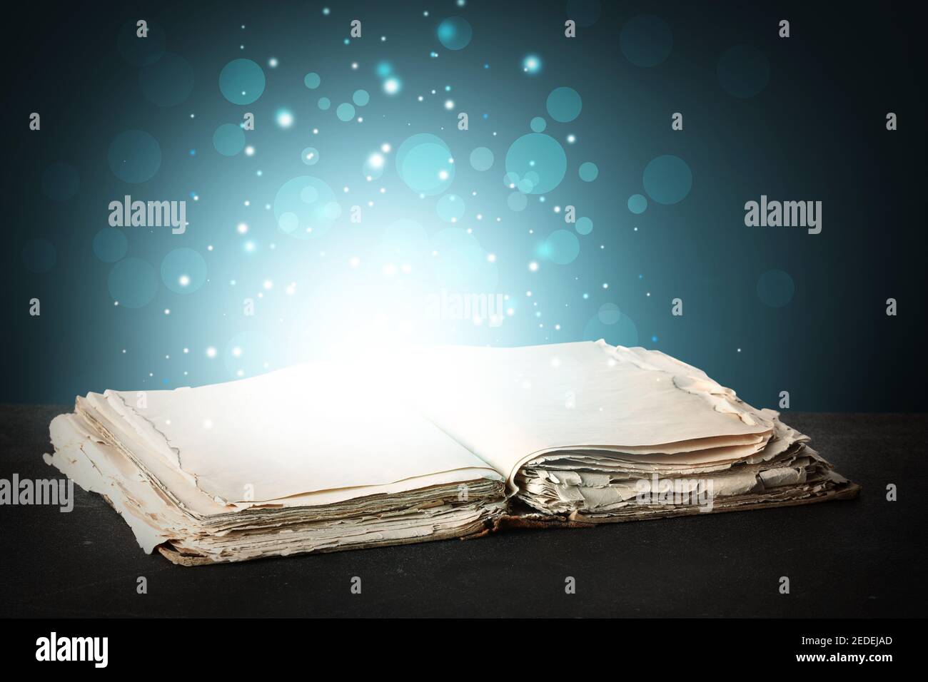 Open magic book on dark background Stock Photo - Alamy