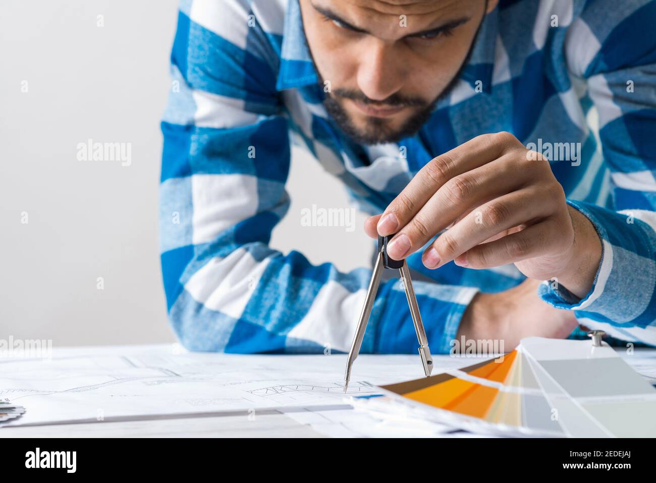 Man measuring with compass divider on blueprint Stock Photo - Alamy