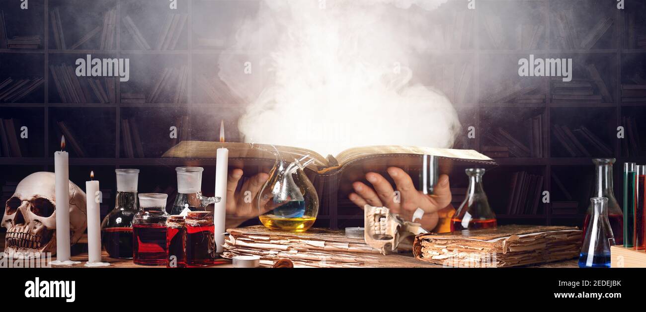 Alchemist making potion in laboratory Stock Photo - Alamy