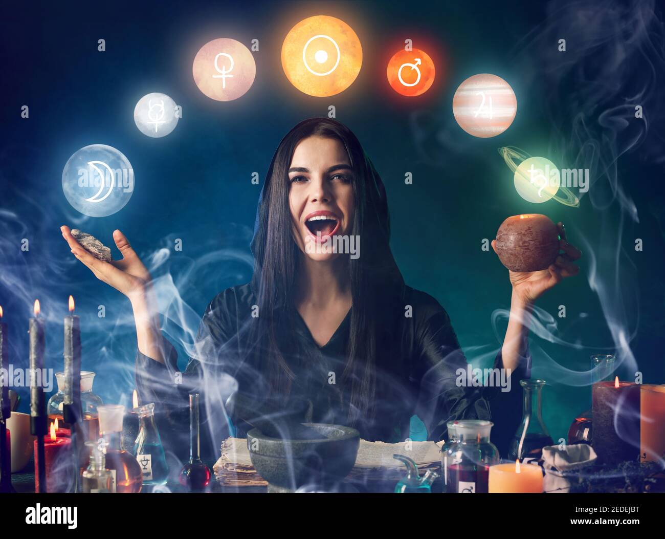 Female alchemist making potion on dark background Stock Photo - Alamy