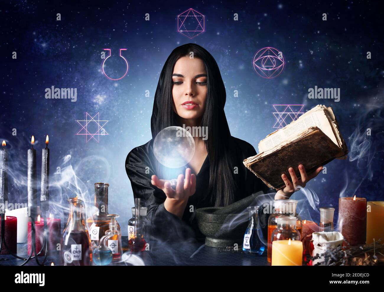 Female alchemist making potion on dark background Stock Photo - Alamy