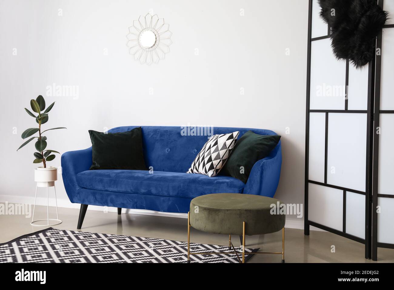 Interior of modern room with blue sofa Stock Photo - Alamy