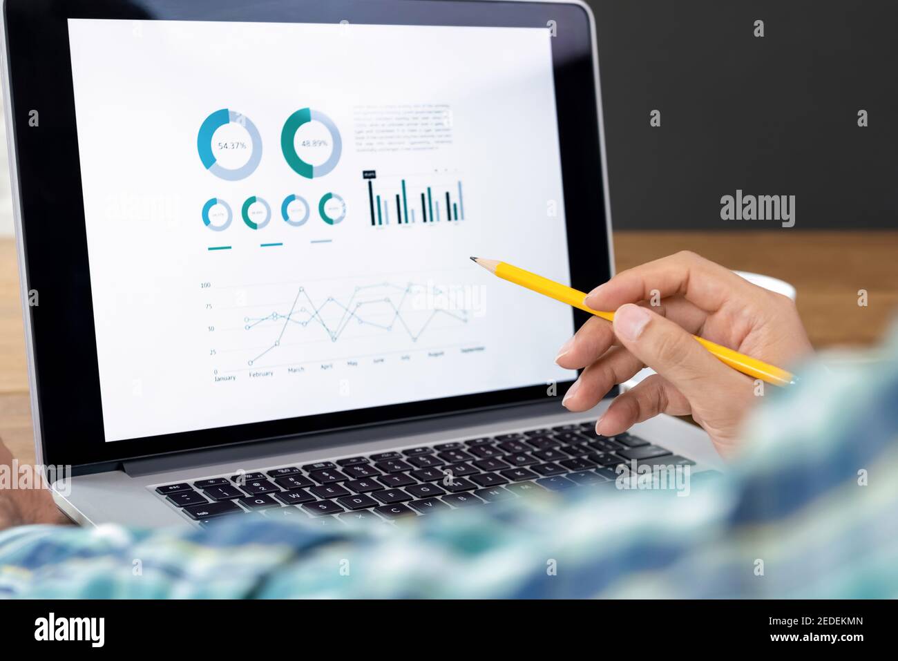 Man analyzing and studying financial business graphs and diagrams ...
