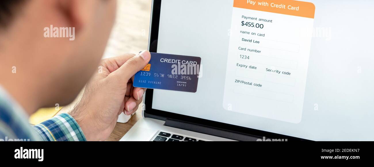 Hand of a man holding credit card making business payment transaction ...