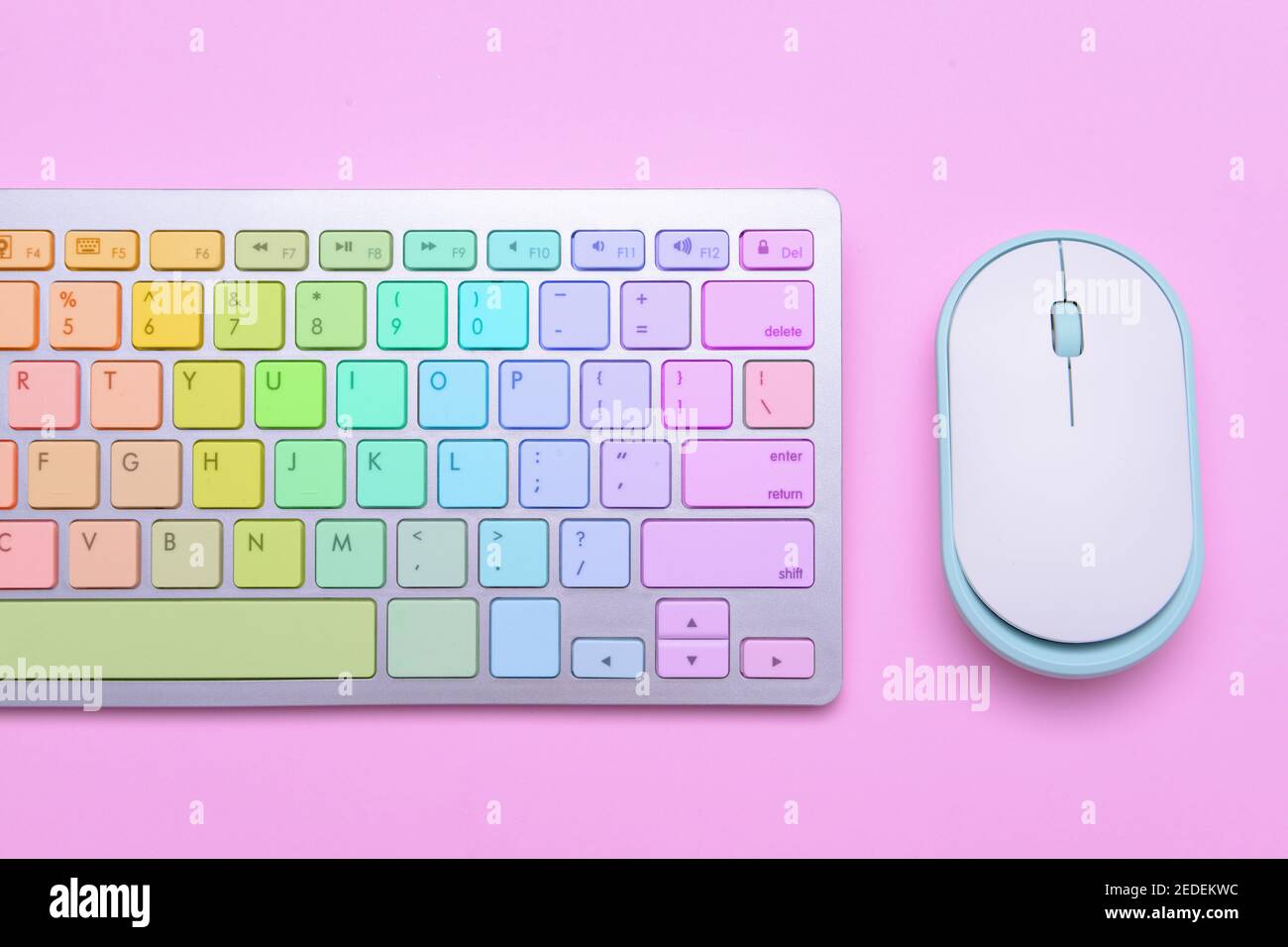 Colorful computer keyboard and mouse on pink background Stock Photo - Alamy