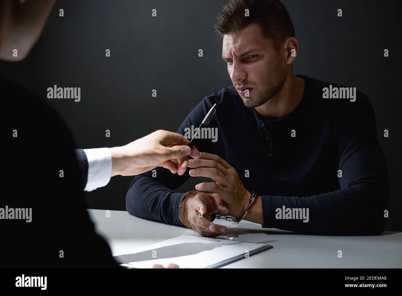 Criminal man in interrogation room being interrogated and refusing to ...