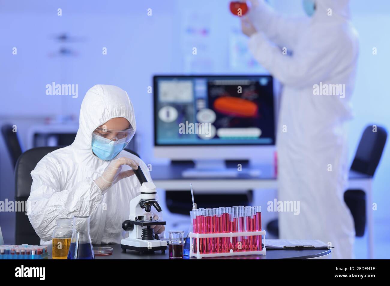 Scientist studying sample in laboratory Stock Photo - Alamy