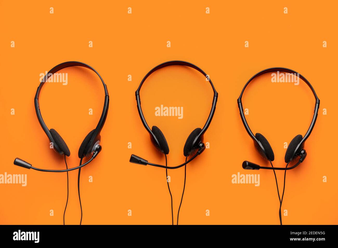 Headphones with microphone on color background Stock Photo - Alamy