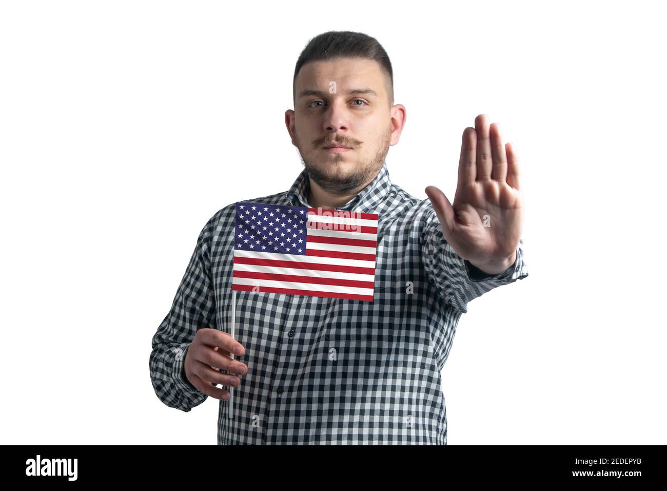White guy holding a flag of United States and with a serious face shows ...