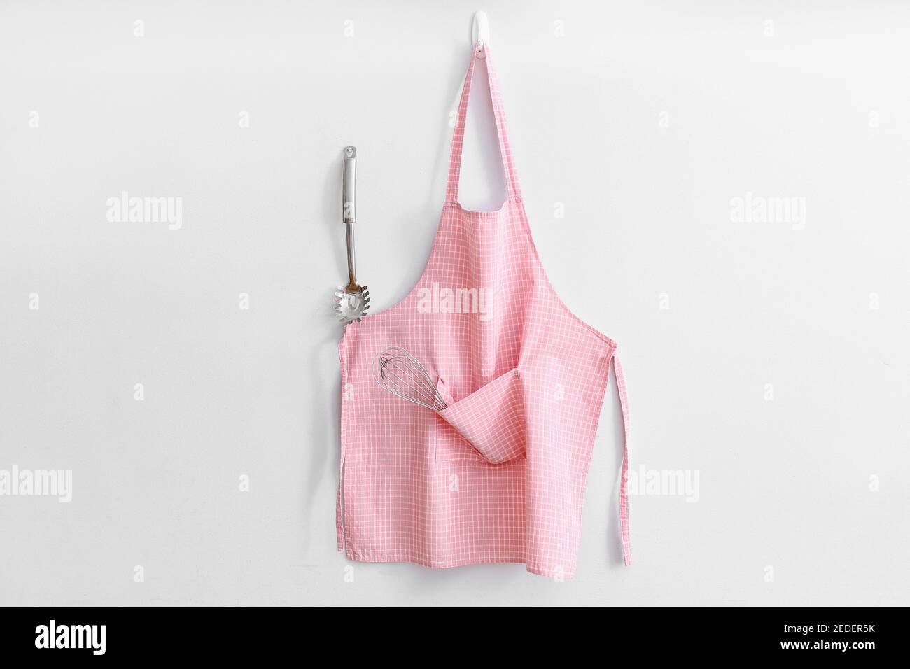 Clean apron and kitchen utensils on white background Stock Photo - Alamy
