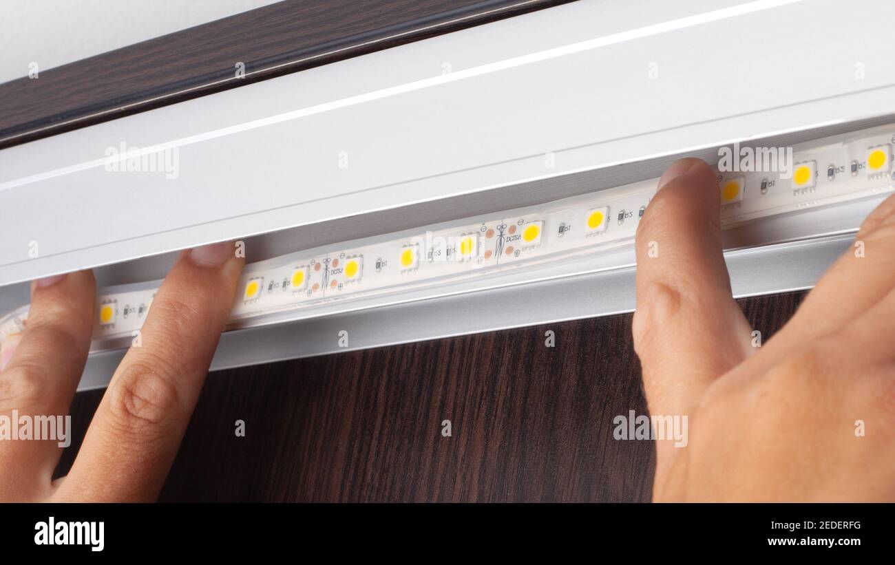 installation of decorative LED strip. diode line mounting Stock Photo ...