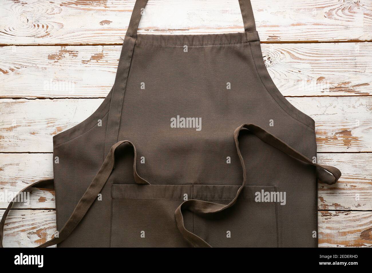 Clean apron on wooden background Stock Photo - Alamy