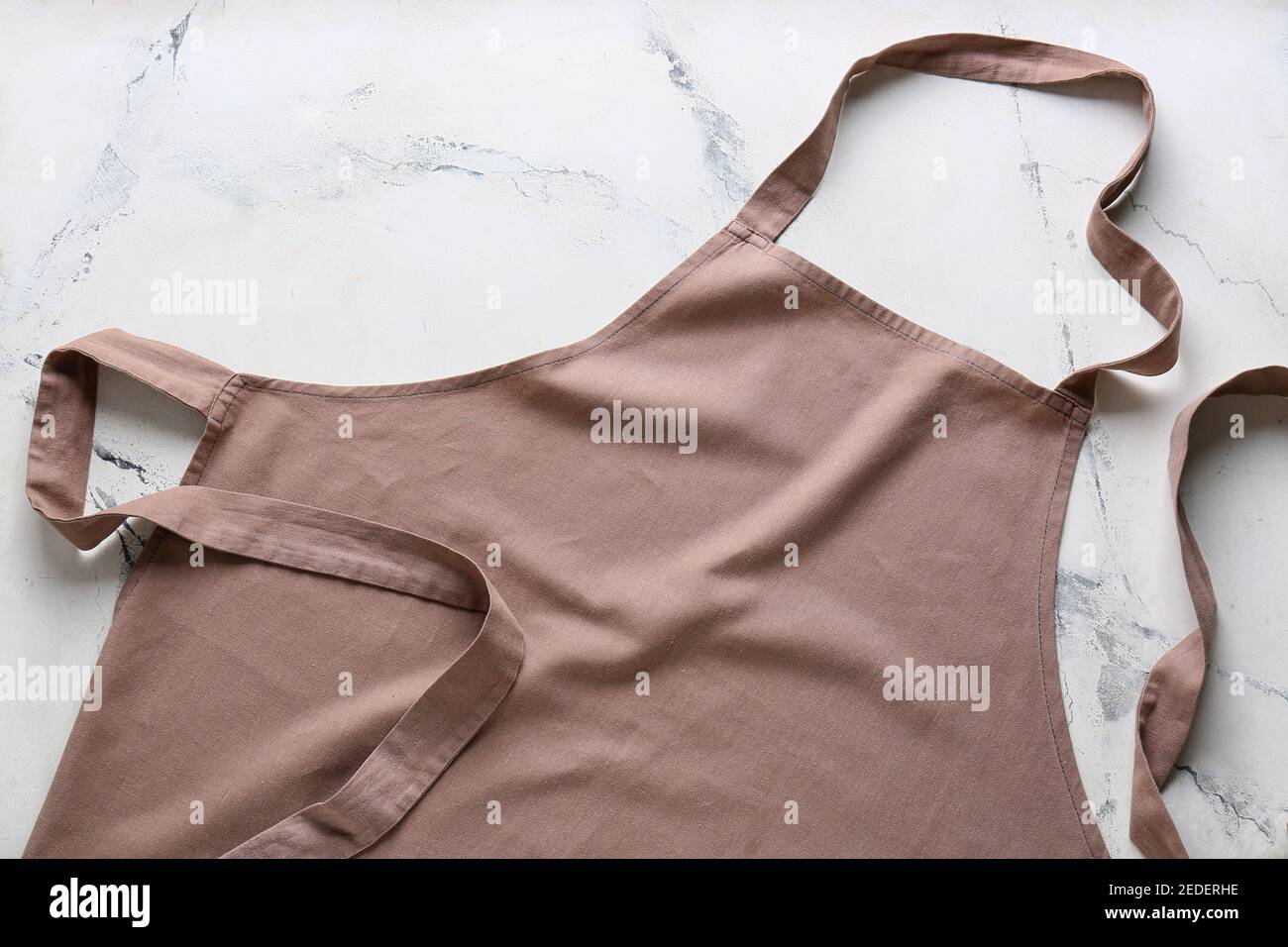 Clean apron on light background Stock Photo - Alamy