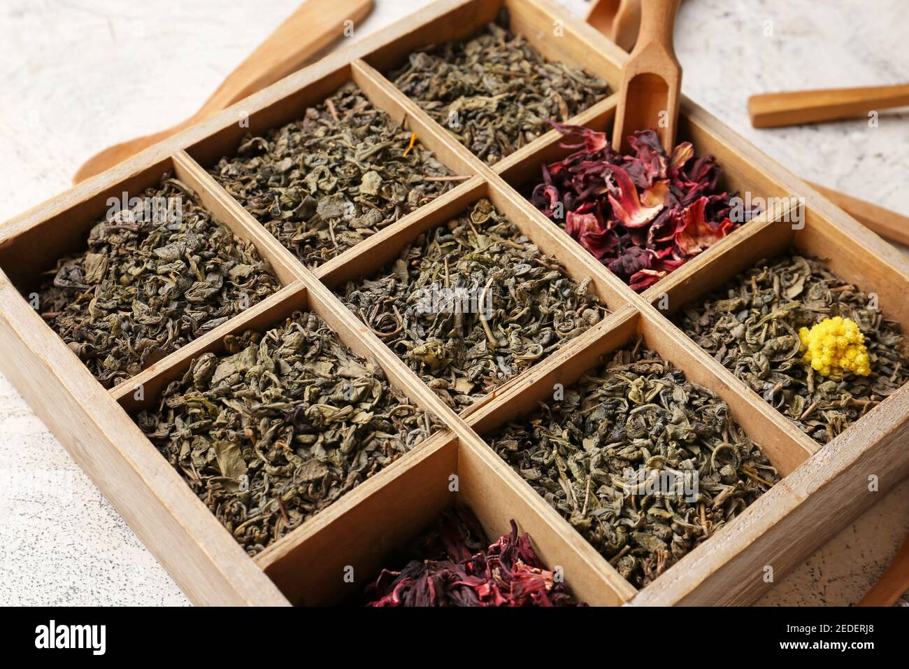 Box with dry green tea on light background Stock Photo - Alamy