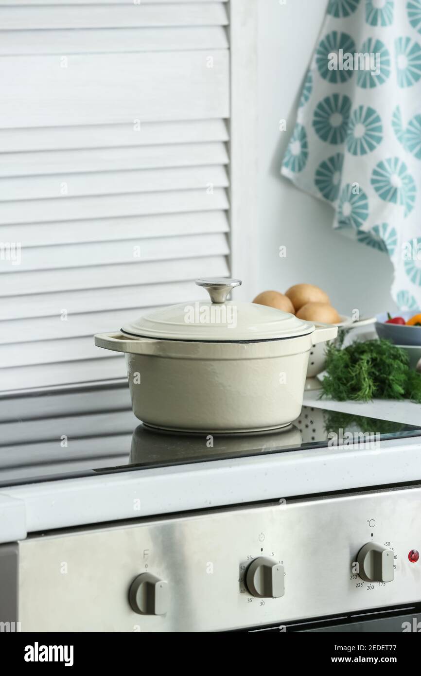 Cooking pot on electric stove in kitchen Stock Photo - Alamy