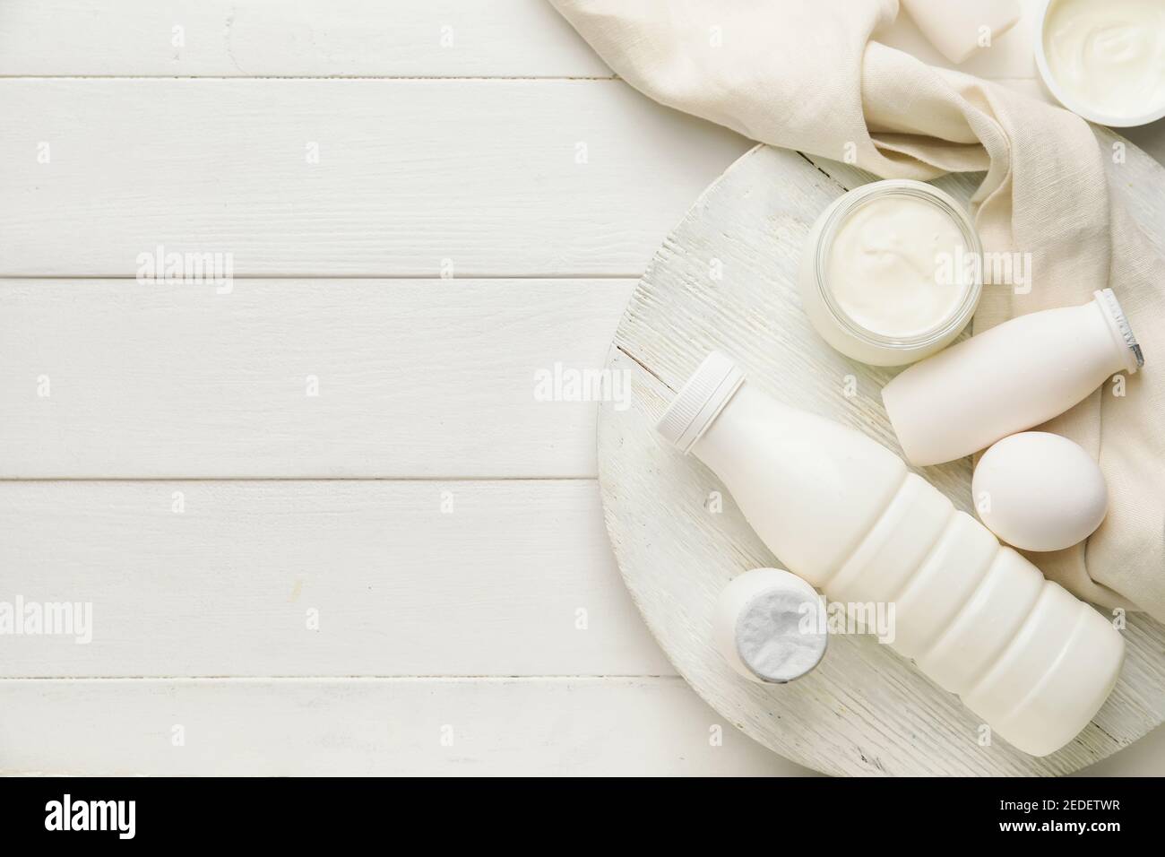 Different dairy products without lactose on light wooden background ...
