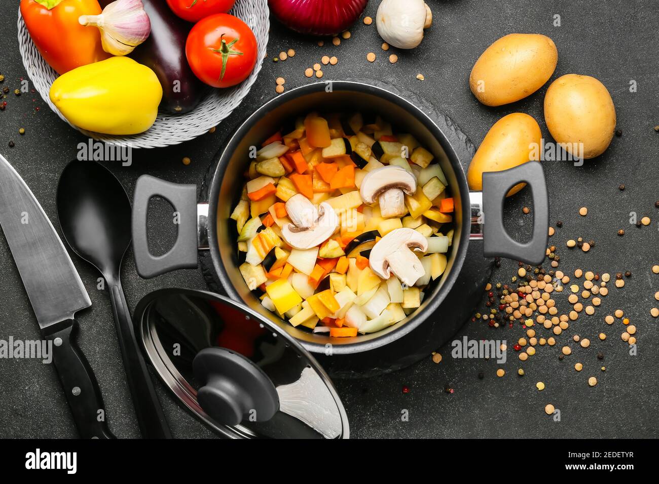 Vegetables in cooking pot on dark background Stock Photo - Alamy