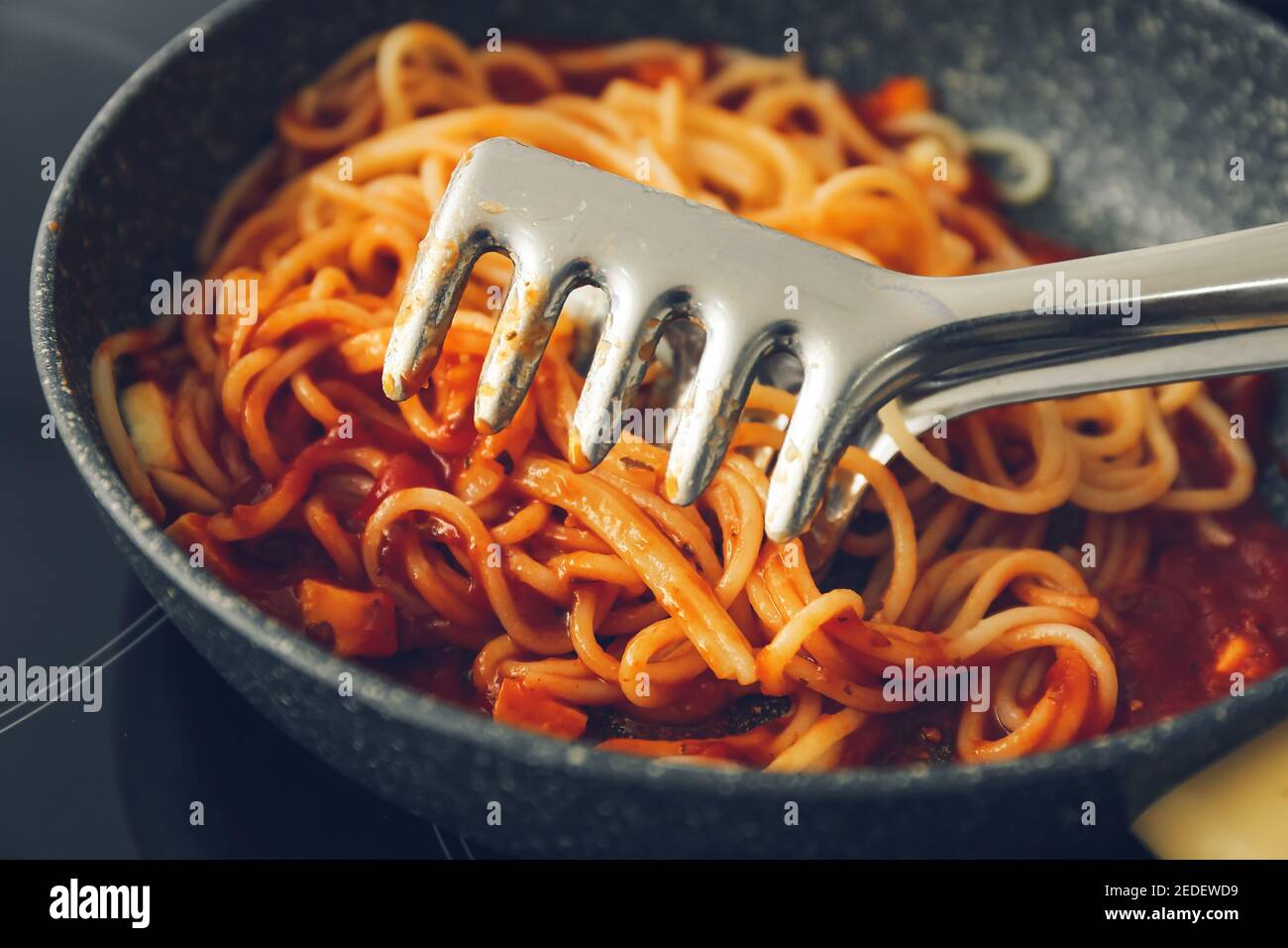 Frying pan with tasty pasta in kitchen Stock Photo - Alamy