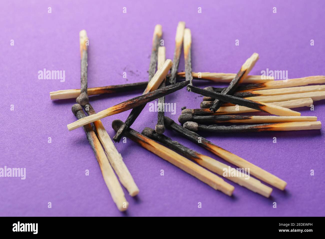Burnt out matches on color background Stock Photo - Alamy