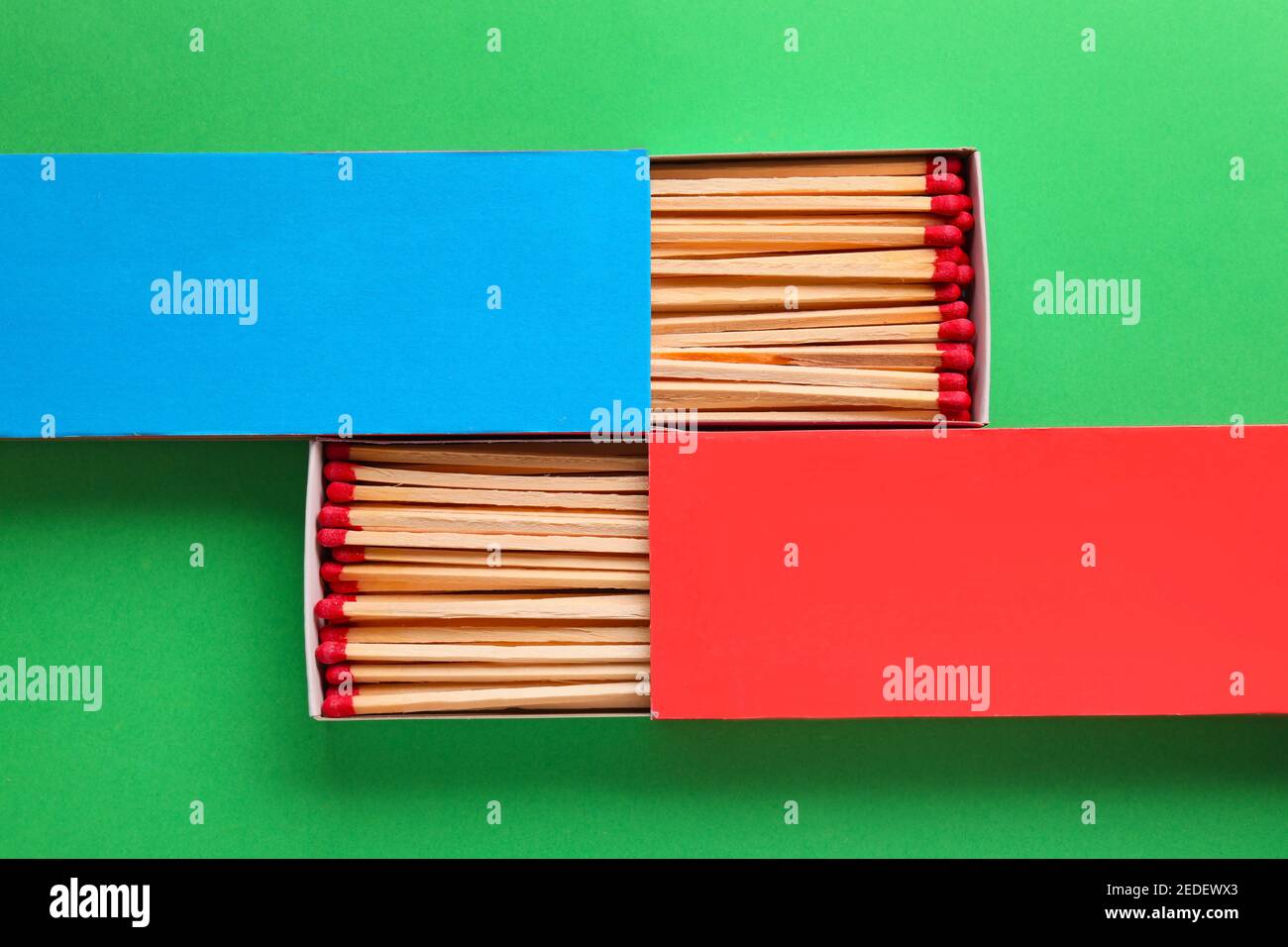 Different boxes with matches on color background Stock Photo - Alamy