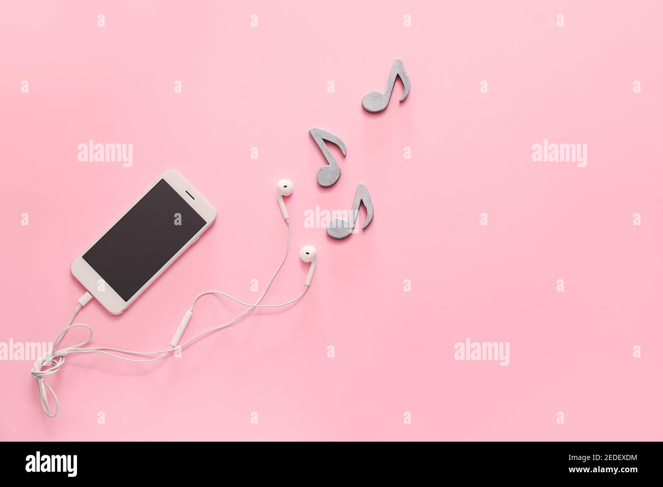 Music notes and mobile phone with earphones on color background Stock ...