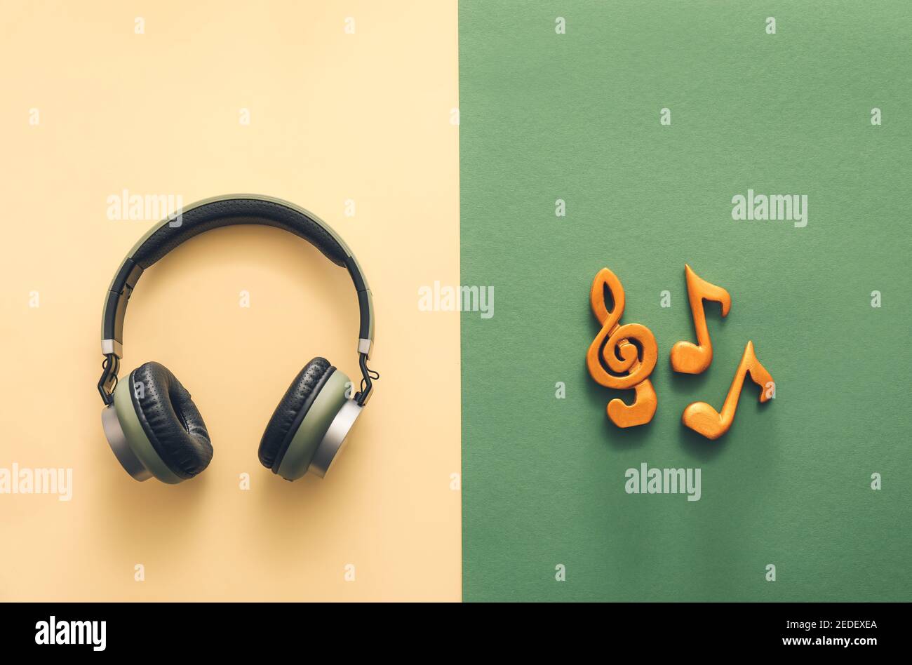 Music notes and headphones on color background Stock Photo - Alamy