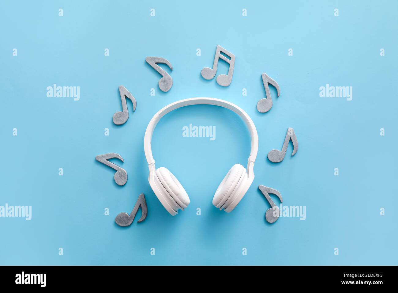 Music notes and headphones on color background Stock Photo - Alamy