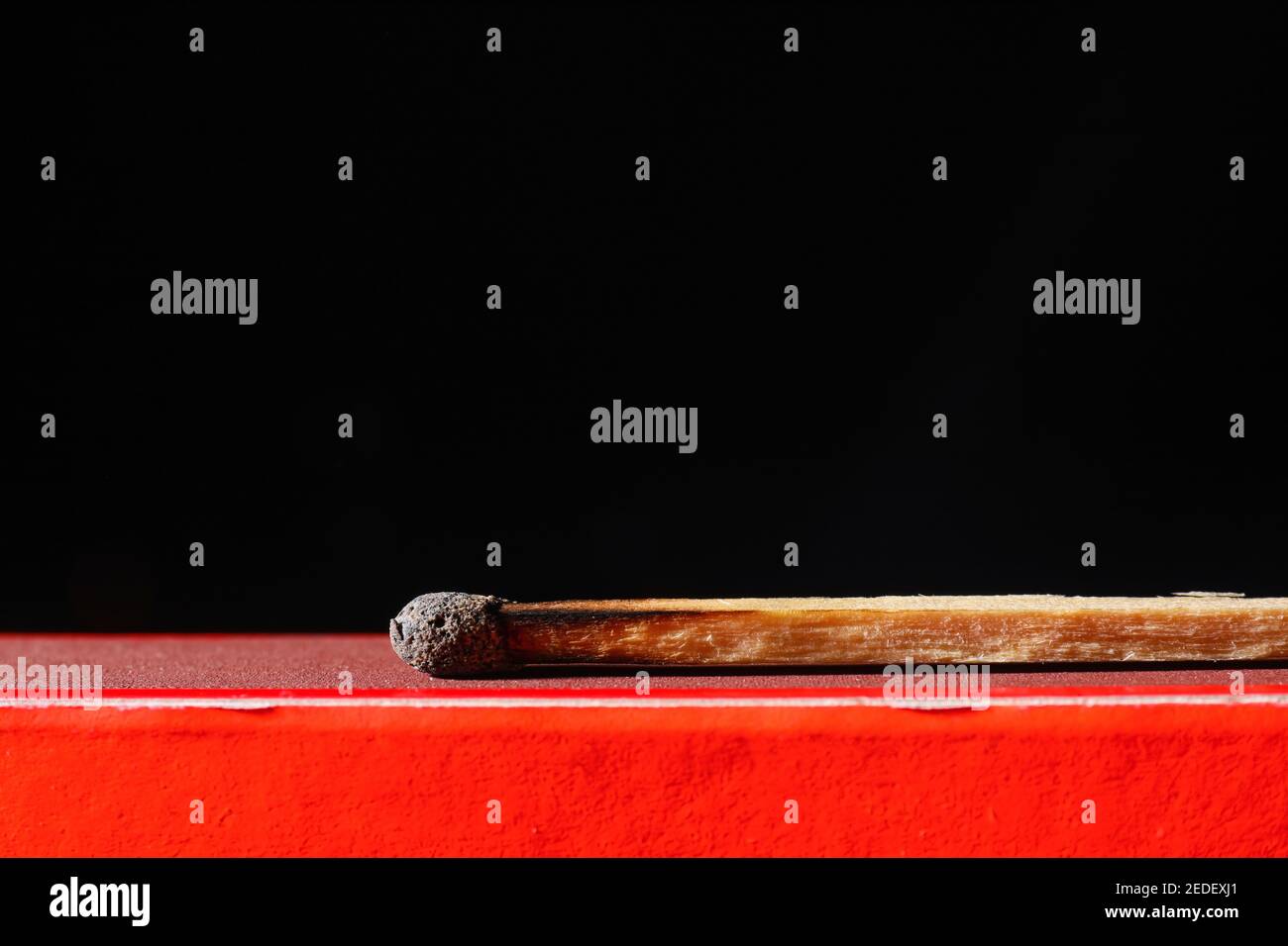 Burnt out match on dark background, closeup Stock Photo - Alamy