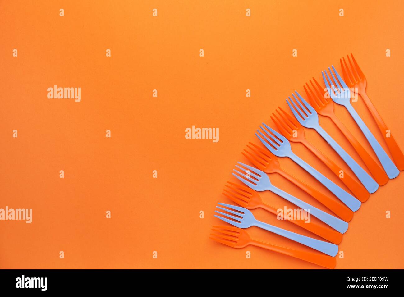 Plastic forks on color background Stock Photo - Alamy