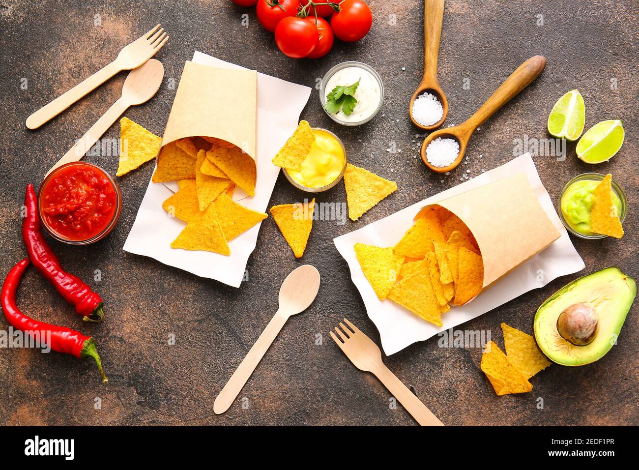 Paper boxes with tasty nachos and sauces on grunge background Stock ...
