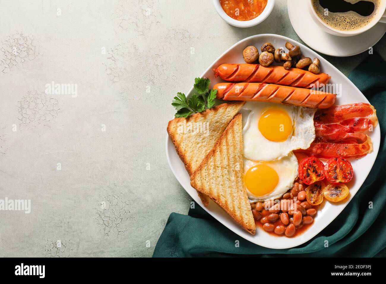 Traditional English breakfast with fried eggs in plate on light ...
