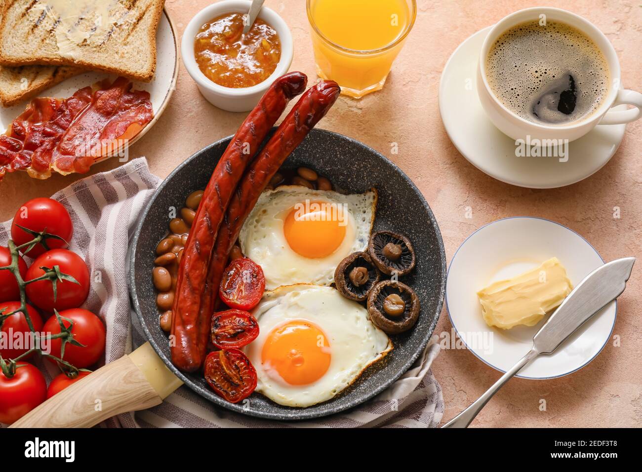 Traditional English breakfast with fried eggs on color background Stock ...