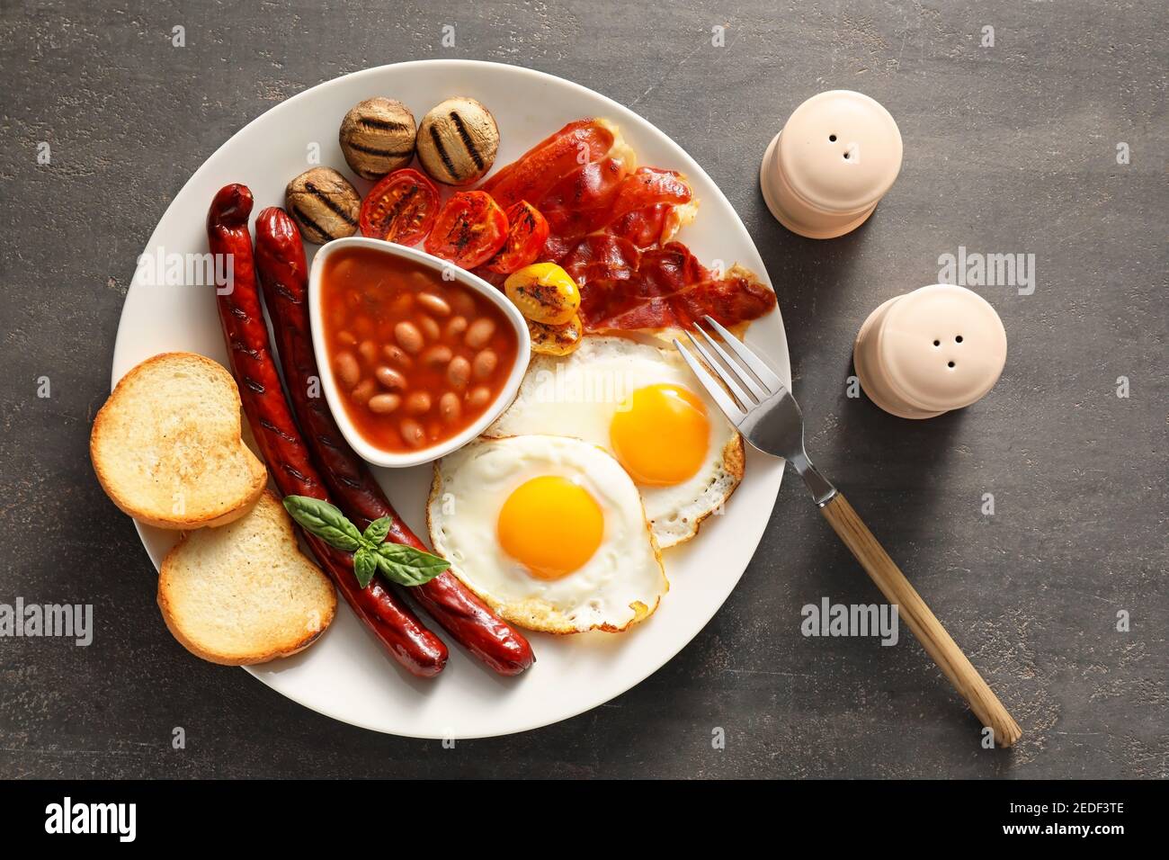 Traditional English breakfast with fried eggs on dark background Stock ...