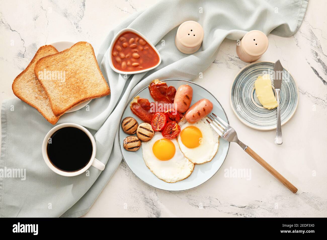 Traditional English breakfast with fried eggs on light background Stock ...