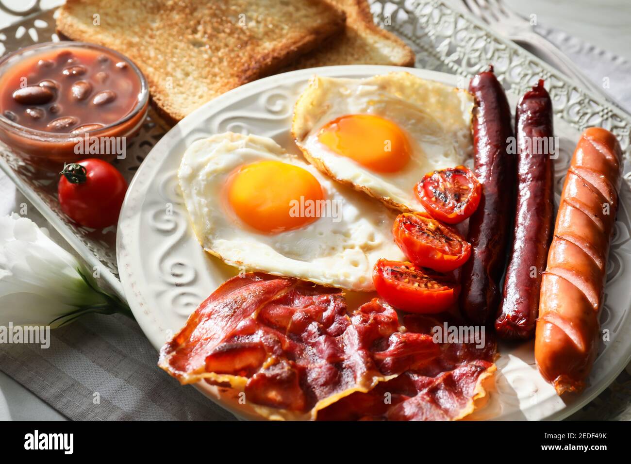 Traditional English breakfast with fried eggs in tray on light ...