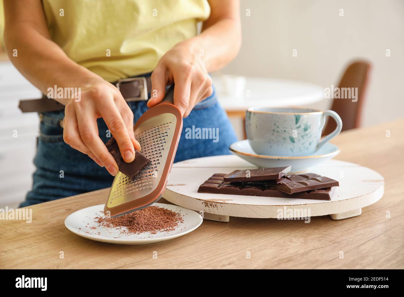 Woman grating chocolate in kitchen Stock Photo - Alamy