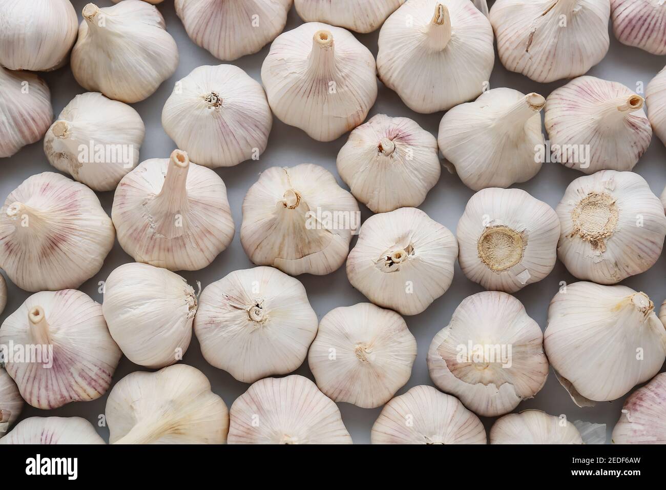 Heap of fresh garlic as background Stock Photo - Alamy