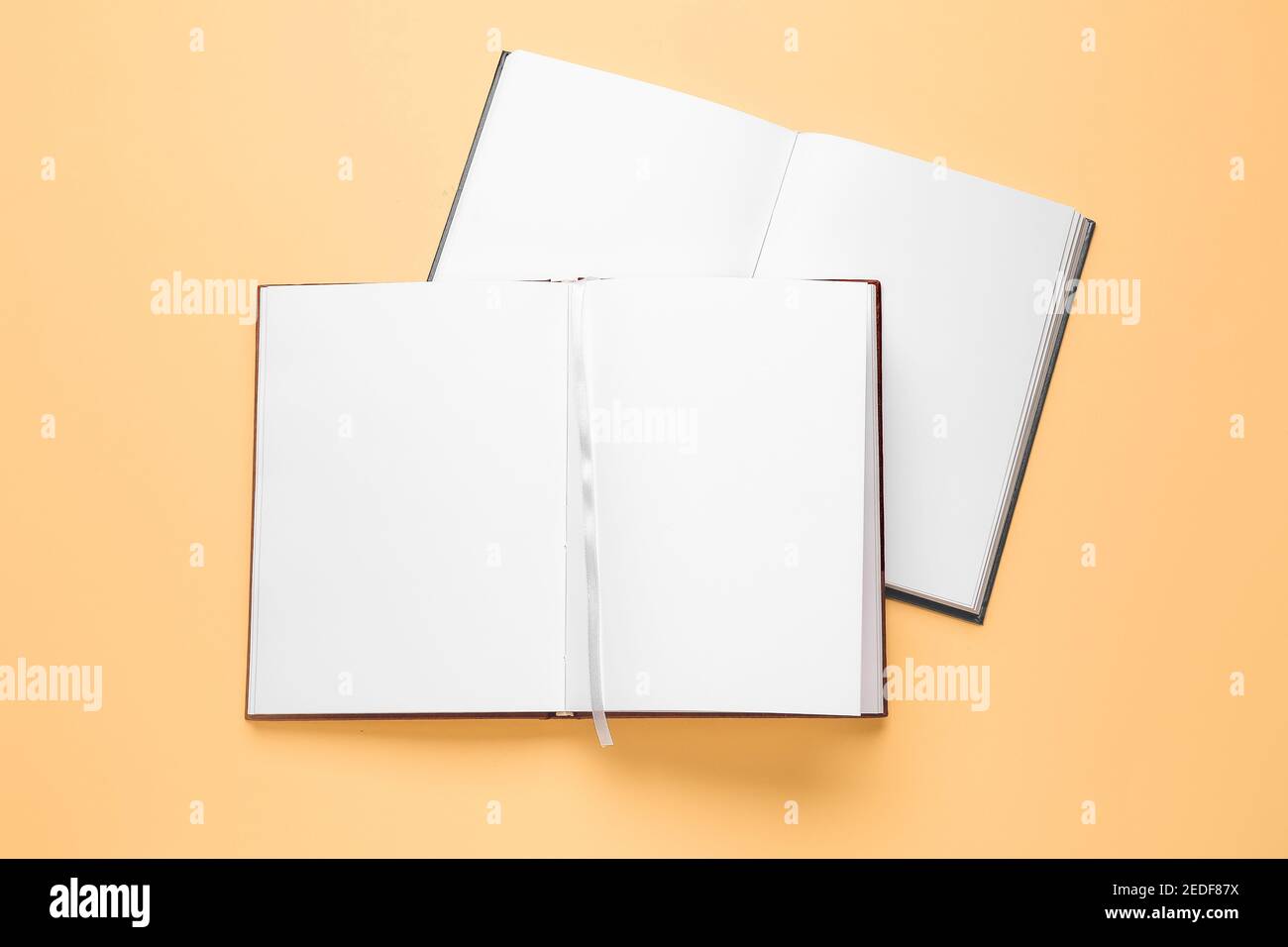 Blank books on color background Stock Photo - Alamy