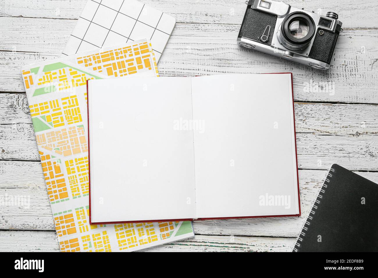 Blank open book, map and photo camera on wooden background Stock Photo ...
