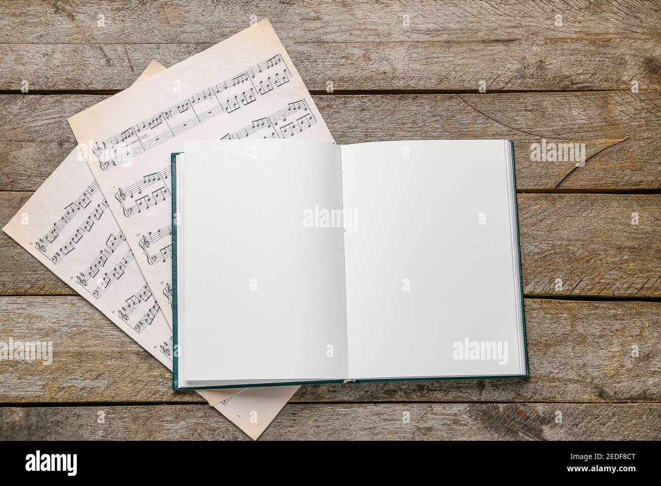 Blank open book and music notes on wooden background Stock Photo - Alamy