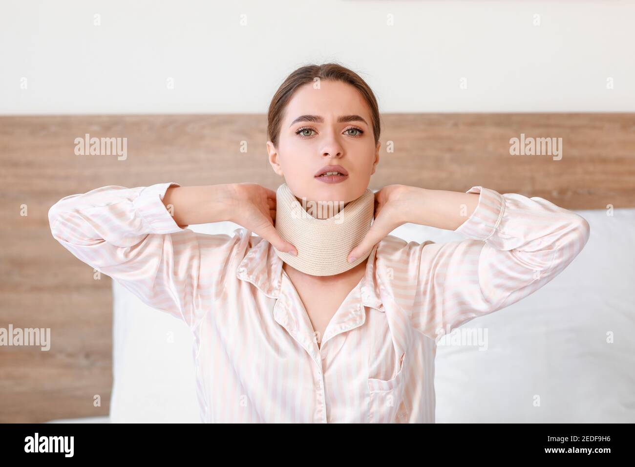Young woman with cervical collar on neck at home Stock Photo - Alamy
