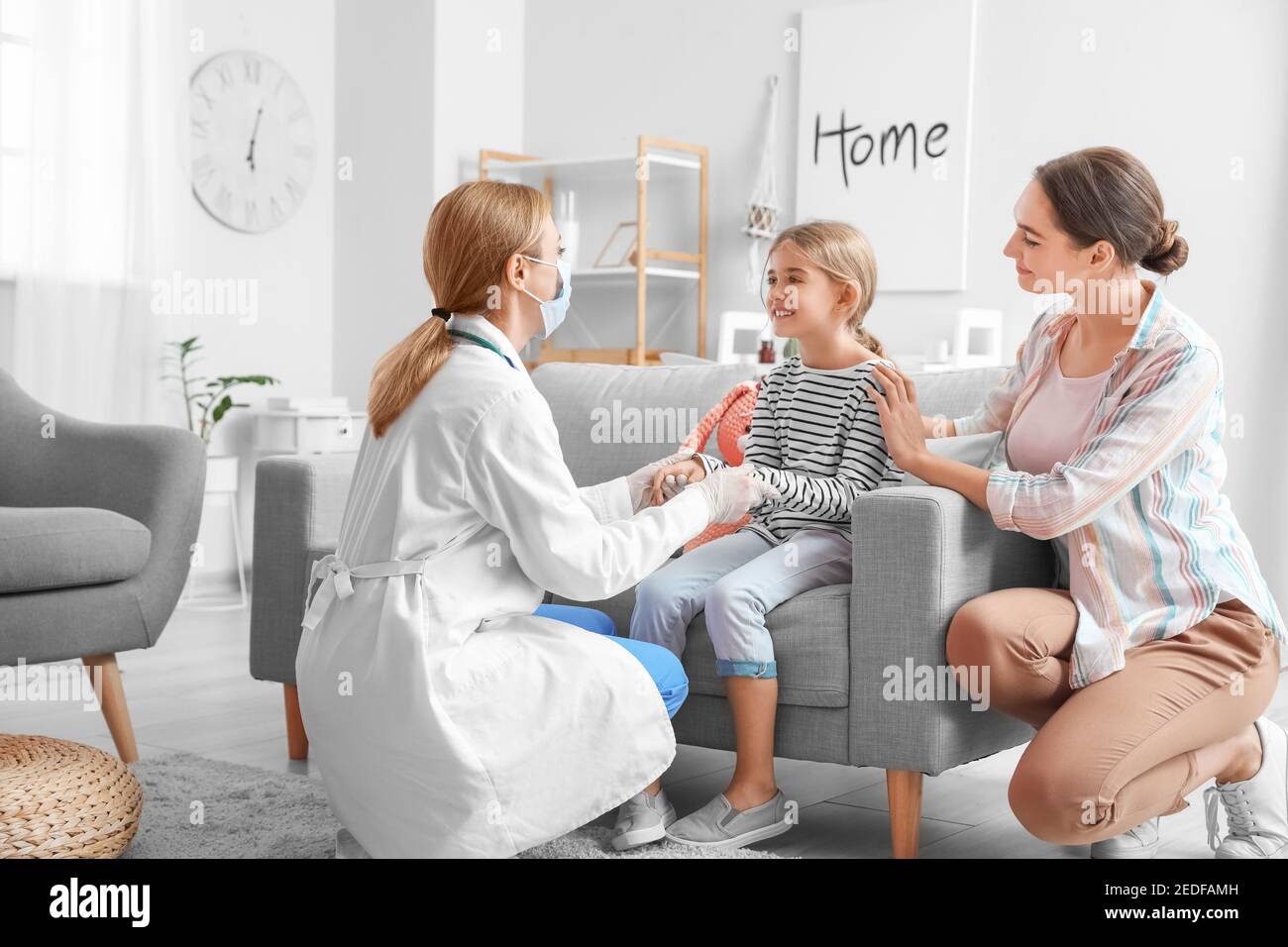 Pediatrician examining little girl at home Stock Photo - Alamy