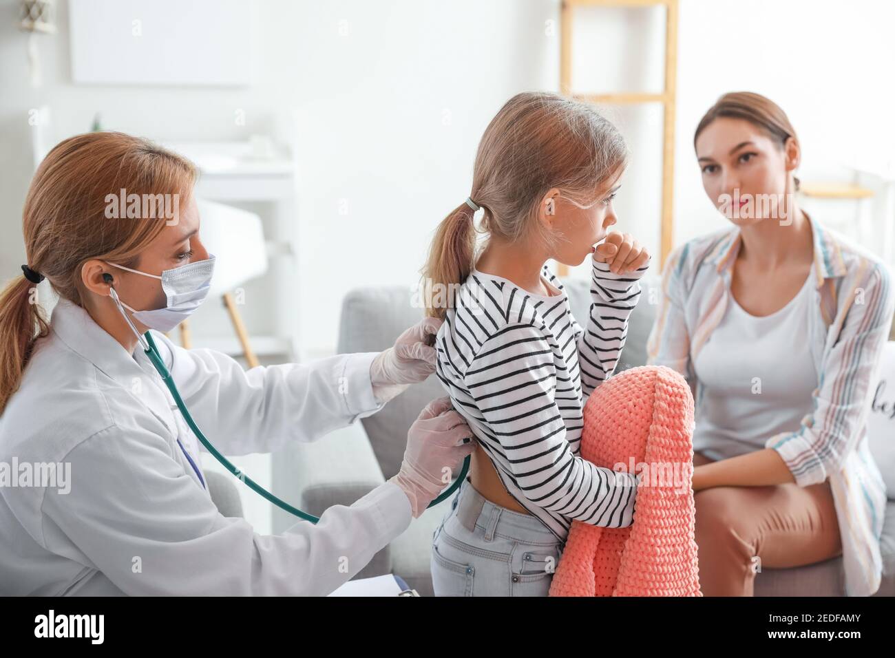 Pediatrician examining little girl at home Stock Photo - Alamy