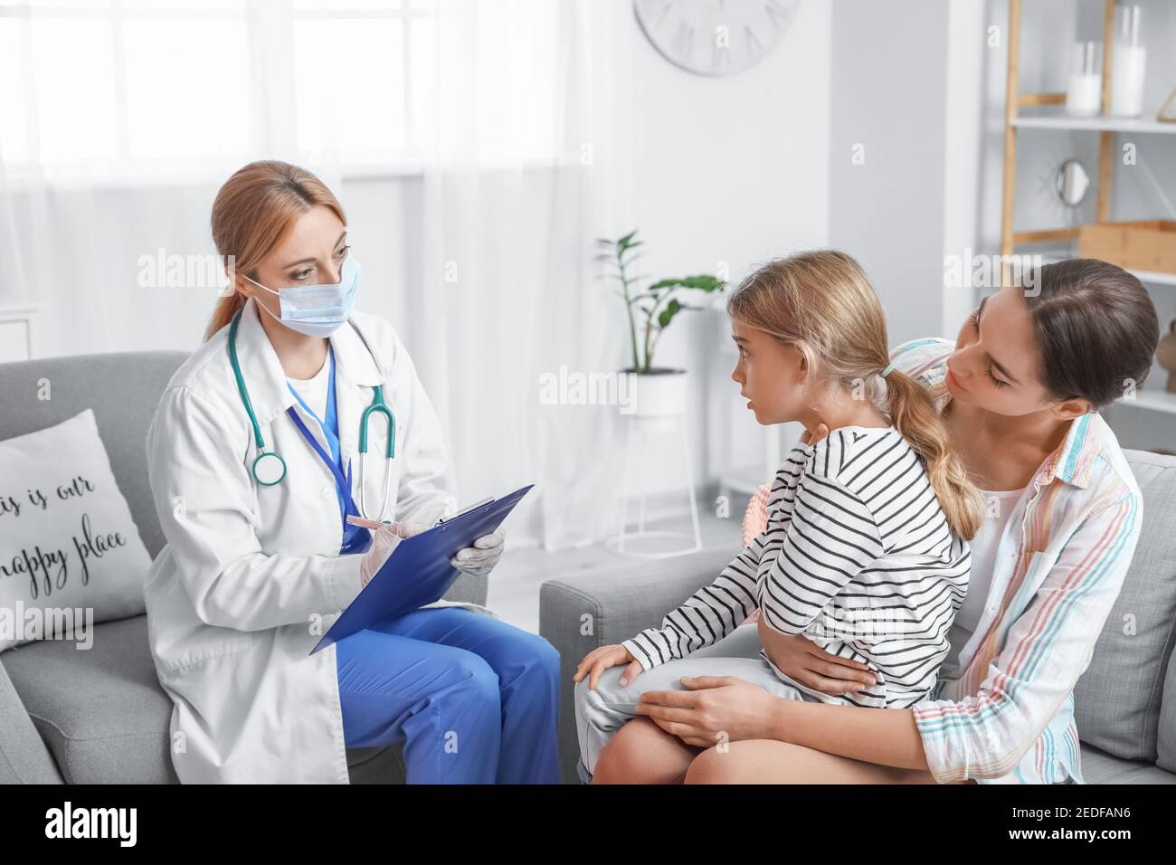 Pediatrician examining little girl at home Stock Photo - Alamy
