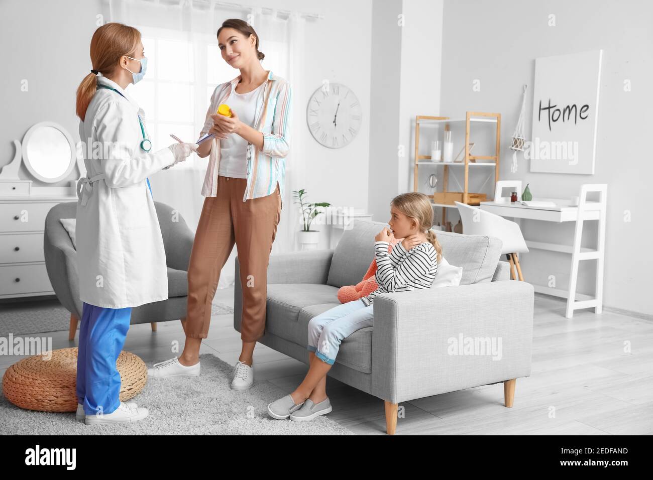 Pediatrician examining little girl at home Stock Photo - Alamy